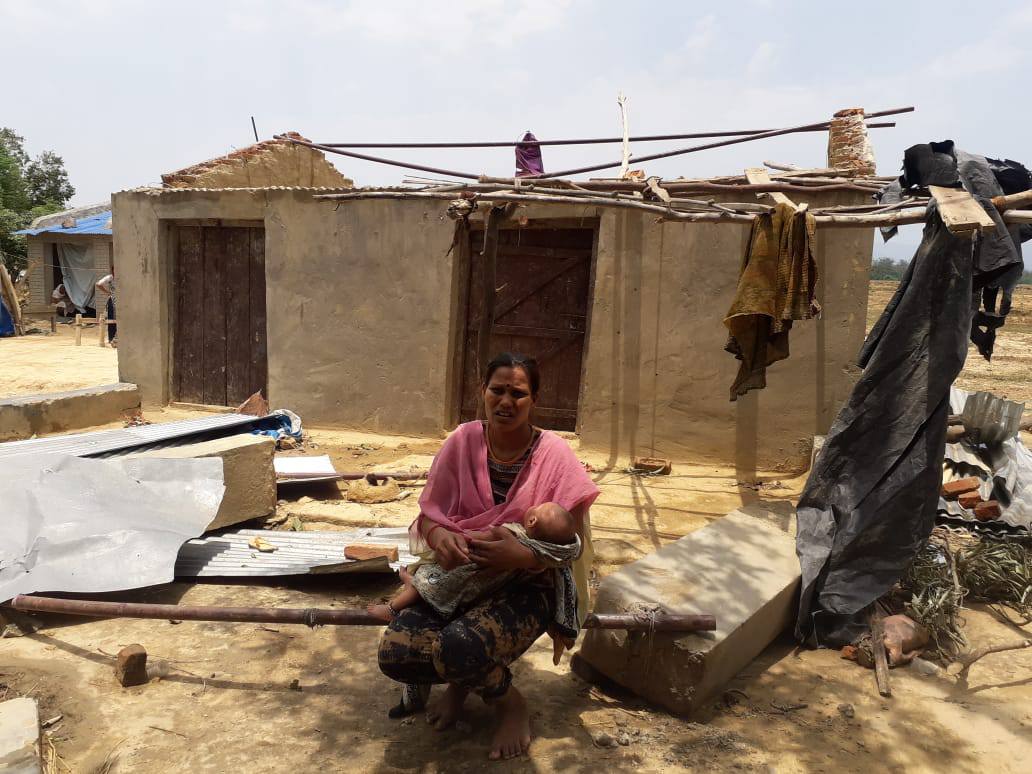 Windstorm victims await relief under the scorching sun